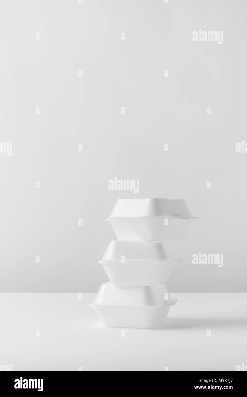 three white food containers on white table Stock Photo - Alamy