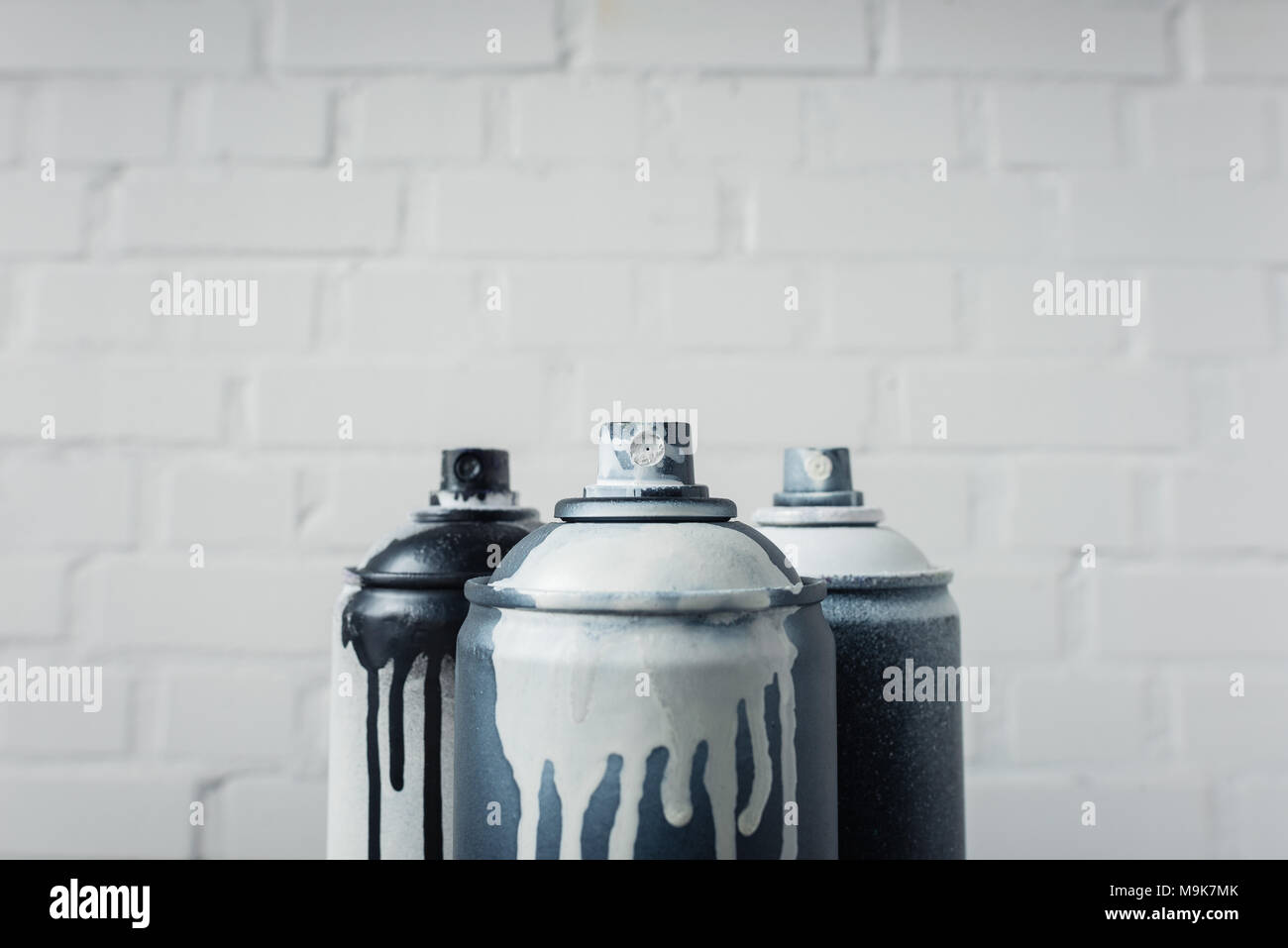close up view of spray paint in cans with brick wall background Stock ...