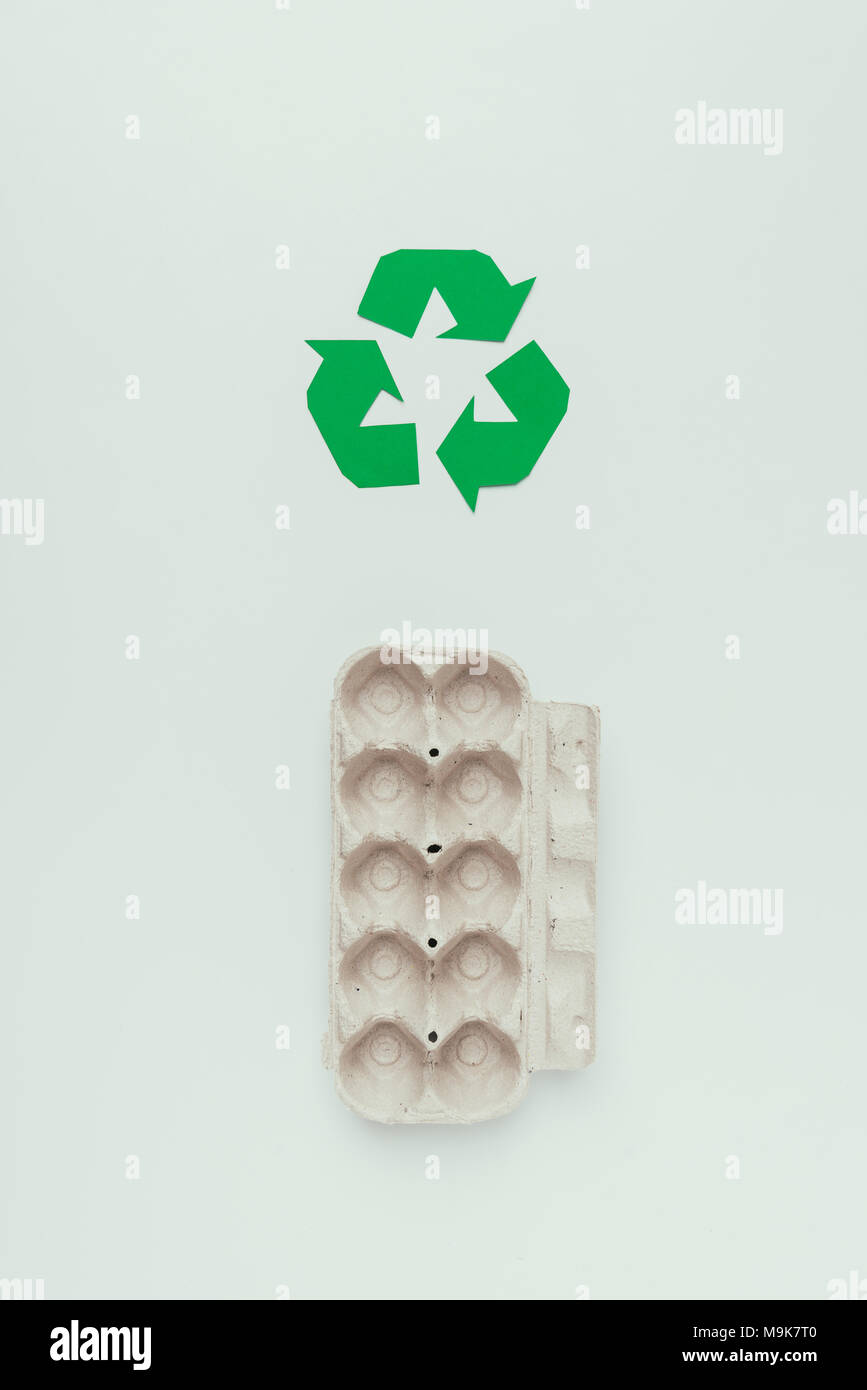 top view of recycle sign and empty carton egg box isolated on grey ...