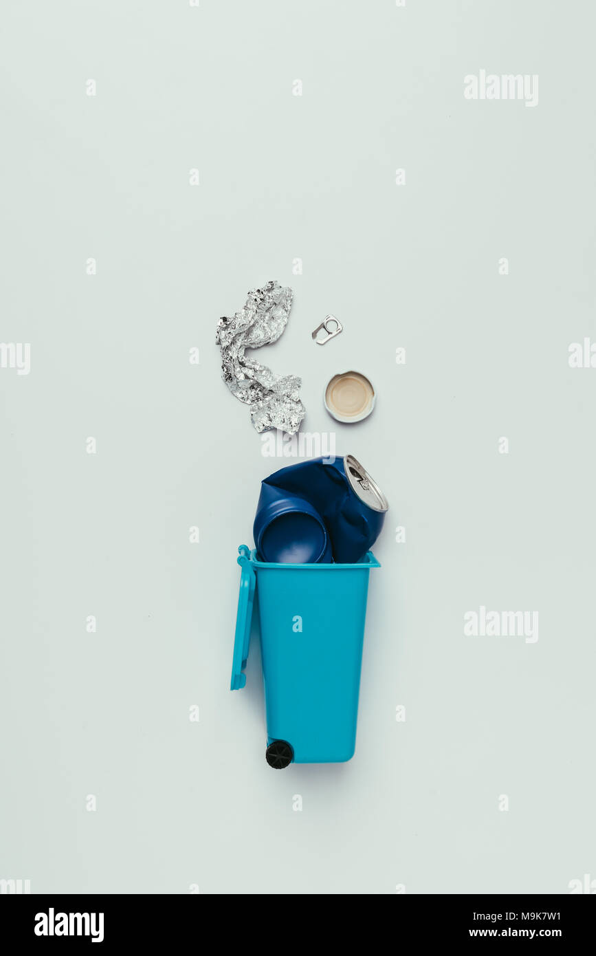 top view of trash bin with assorted garbage isolated on grey, recycling ...
