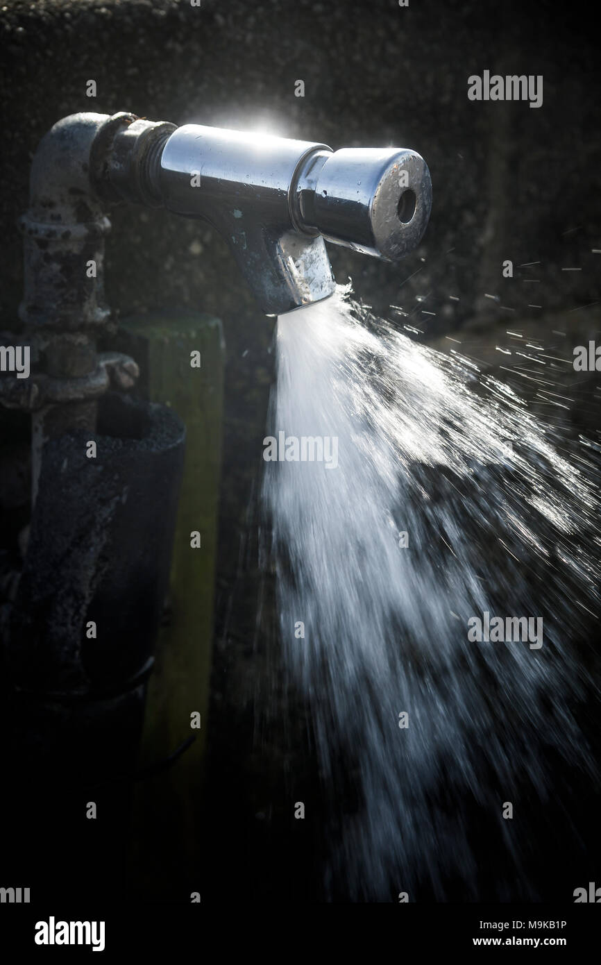 Water gushing from a tap in bright sunshine Stock Photo - Alamy