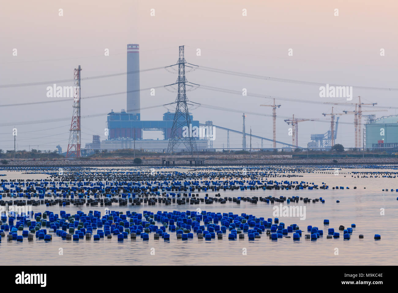 high voltage poles , crain , tower and many tanks floating above the ...