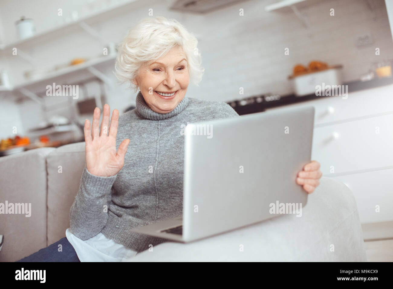 Grandma learns how to work with computer in video chat . Indoor, studio ...