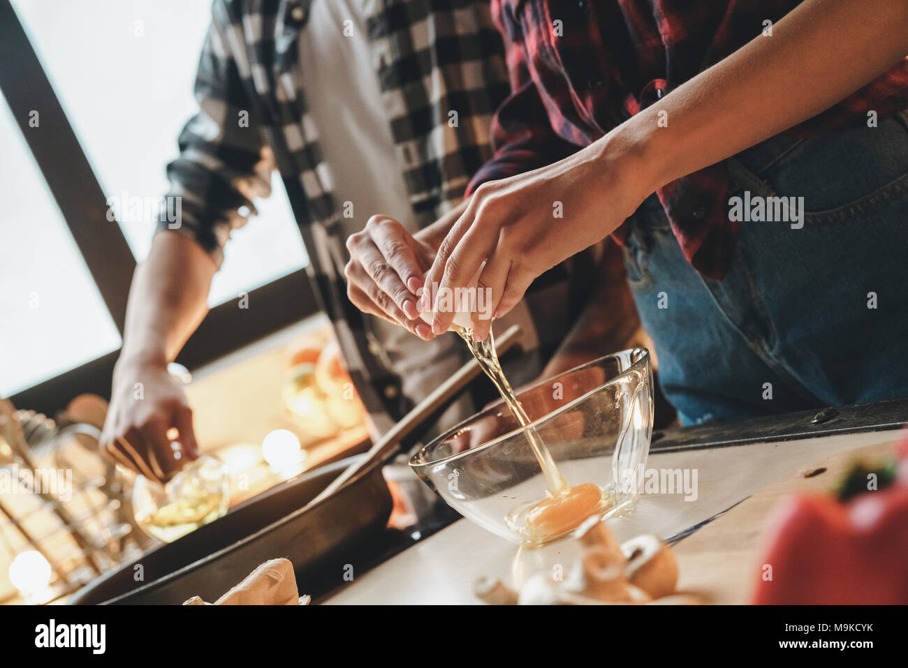 Closeup picture of broken egg flows into a bowl from lunch. Indoor ...