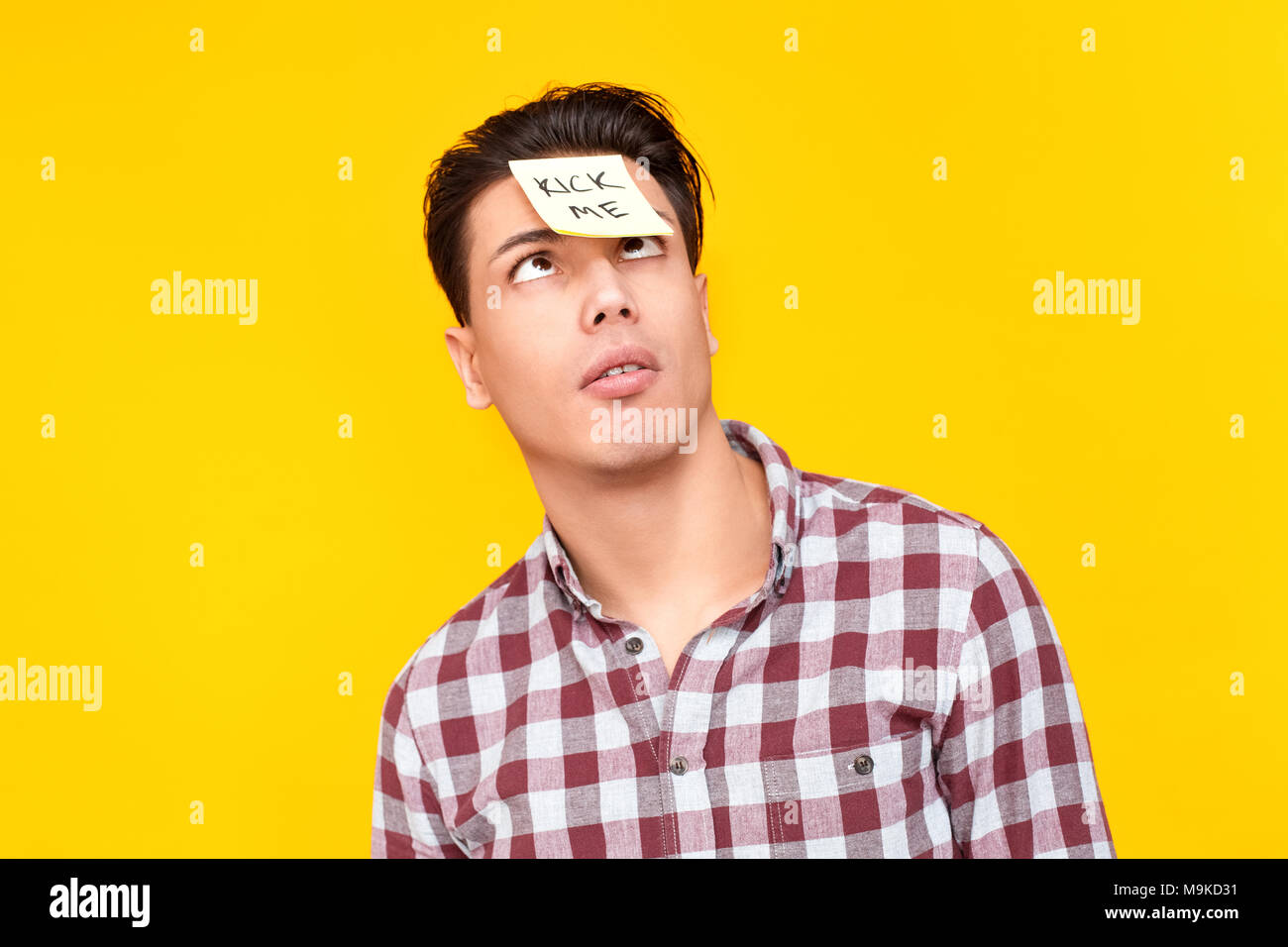 Stupid man looks at the sticker that's on his head. Fool's day emotions ...