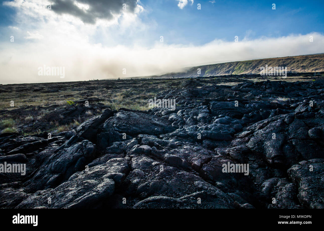 On the edge of an old lava flow looking at a bank of VOG (Volcanic Fog ...