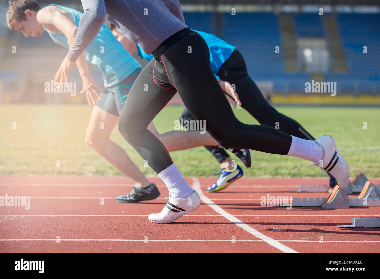 Athletes at the sprint start line in track and field Stock Photo - Alamy