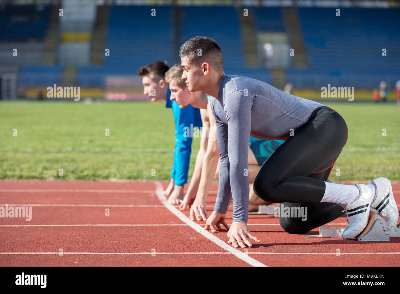 Athletes at the sprint start line in track and field Stock Photo - Alamy