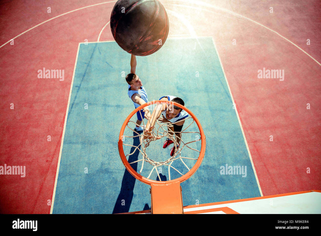 High angle view of basketball player dunking basketball in hoop Stock ...