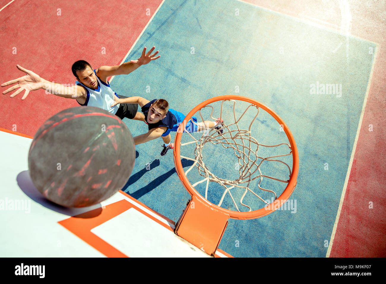 High angle view of basketball player dunking basketball in hoop Stock ...