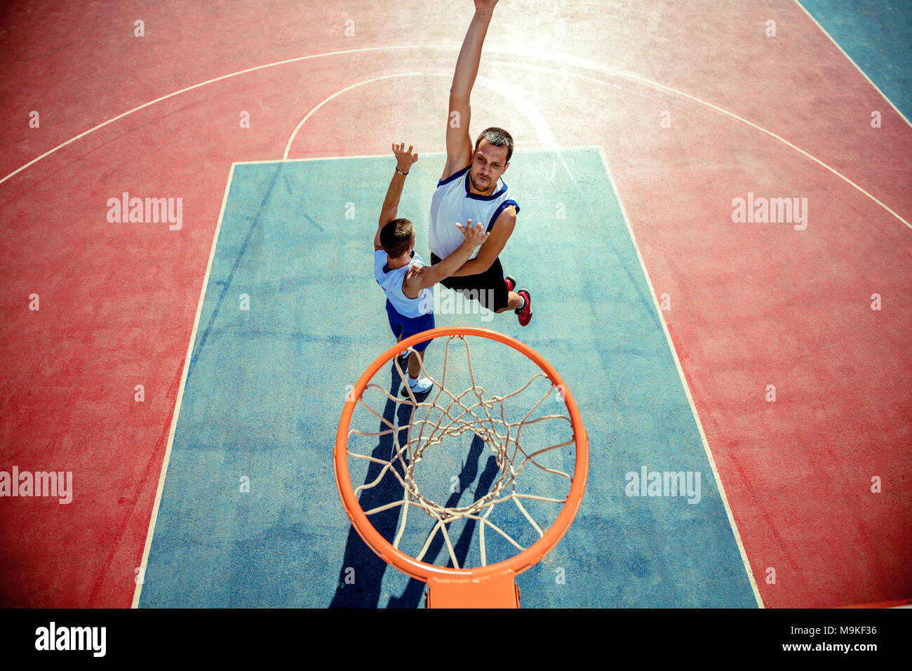 High angle view of basketball player dunking basketball in hoop Stock ...