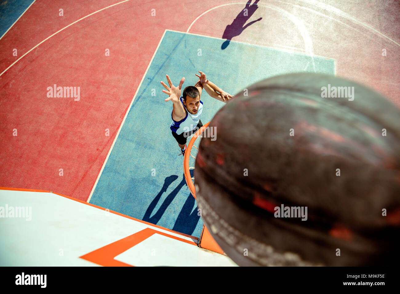 High angle view of basketball player dunking basketball in hoop Stock ...