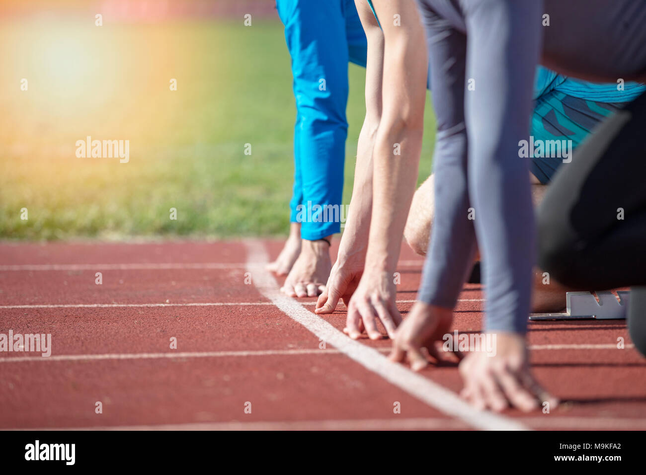 Athletes at the sprint start line in track and field Stock Photo - Alamy