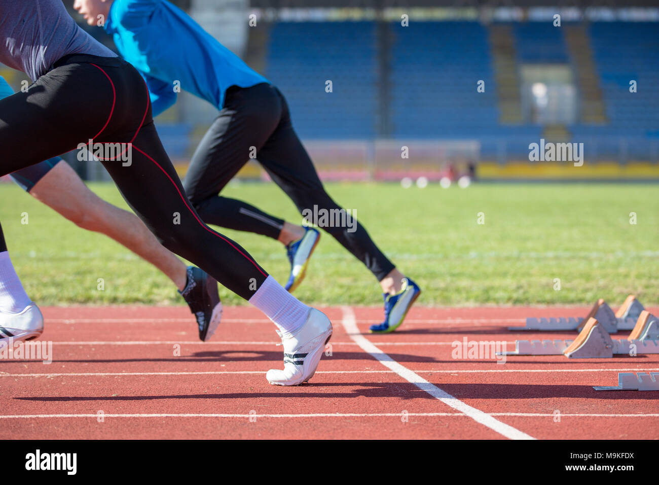 Athletes at the sprint start line in track and field Stock Photo - Alamy
