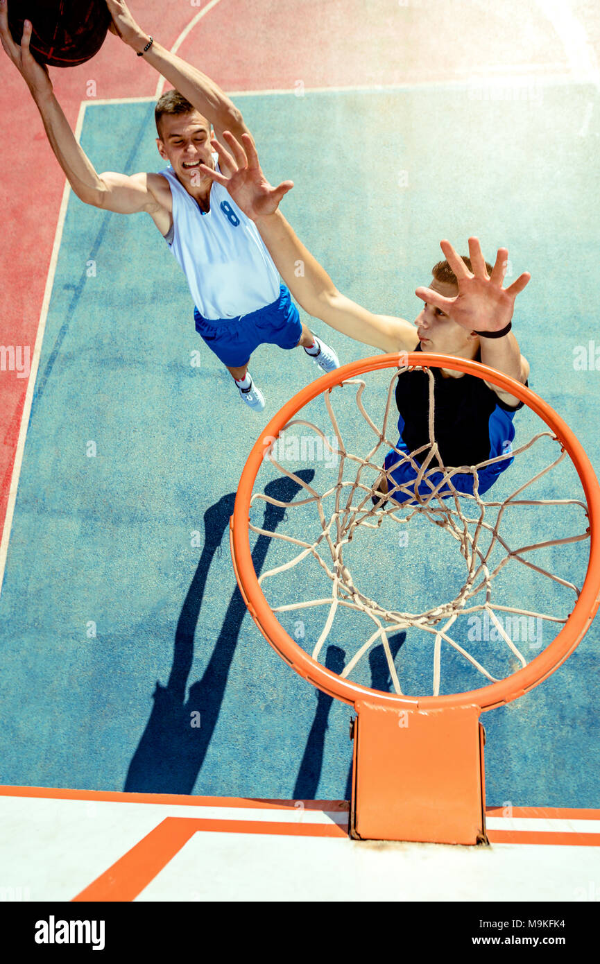 High angle view of basketball player dunking basketball in hoop Stock ...