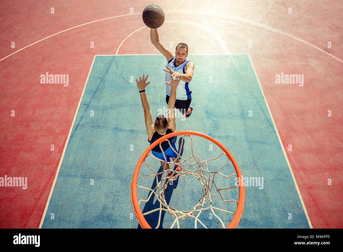 High angle view of basketball player dunking basketball in hoop Stock ...