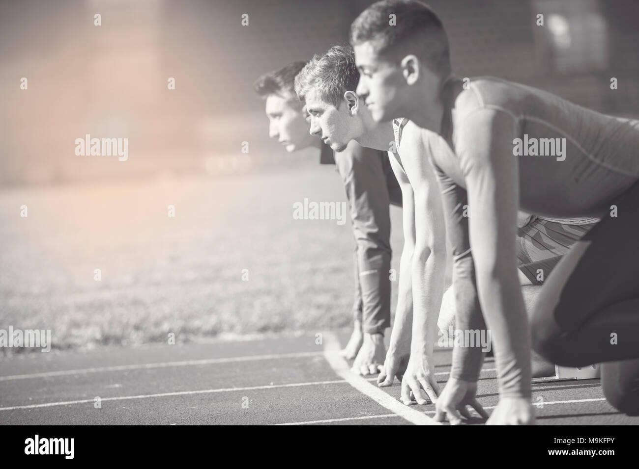 Athletes at the sprint start line in track and field Stock Photo - Alamy