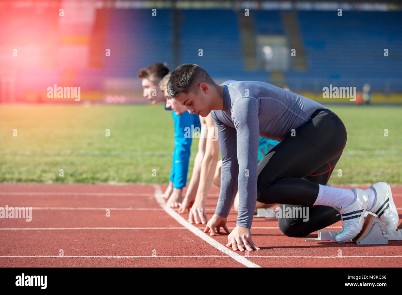 Athletes at the sprint start line in track and field Stock Photo - Alamy