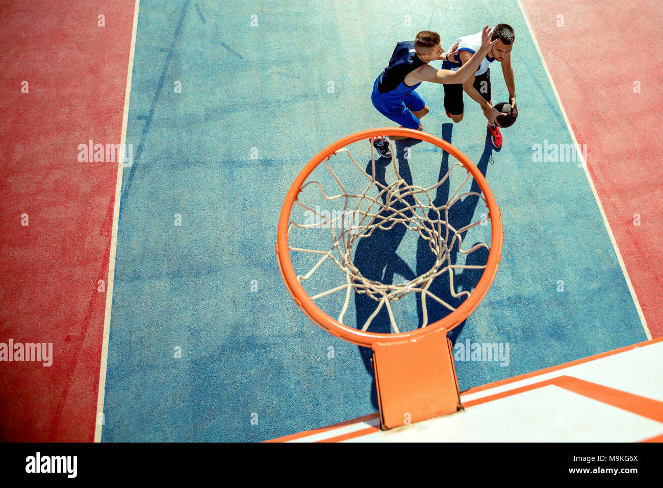 High angle view of basketball player dunking basketball in hoop Stock ...