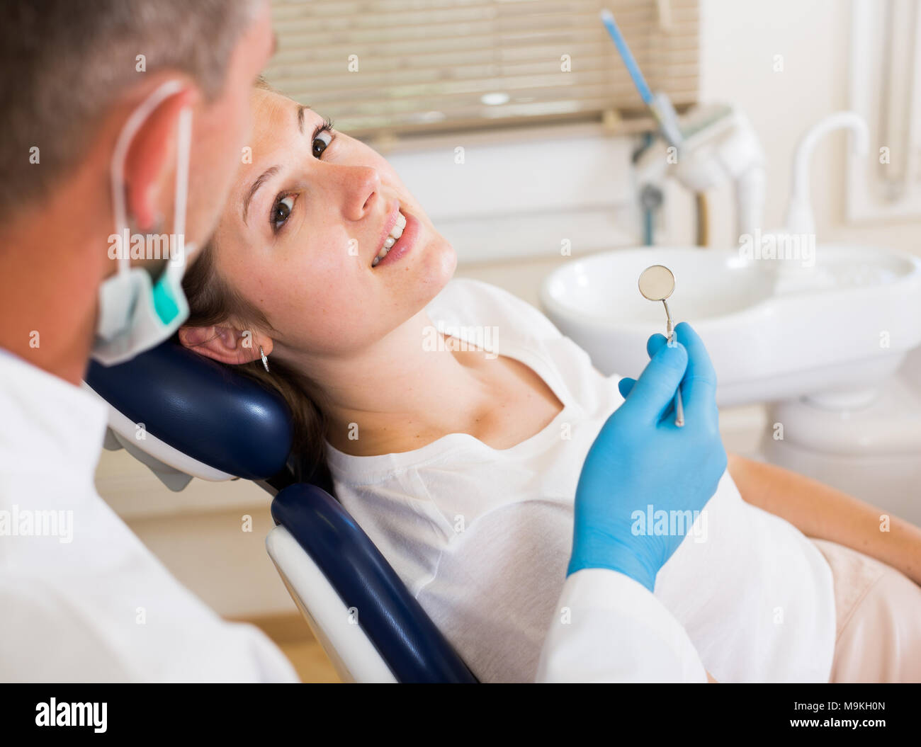 Professional in uniform is taking a view of a young female in clinic ...