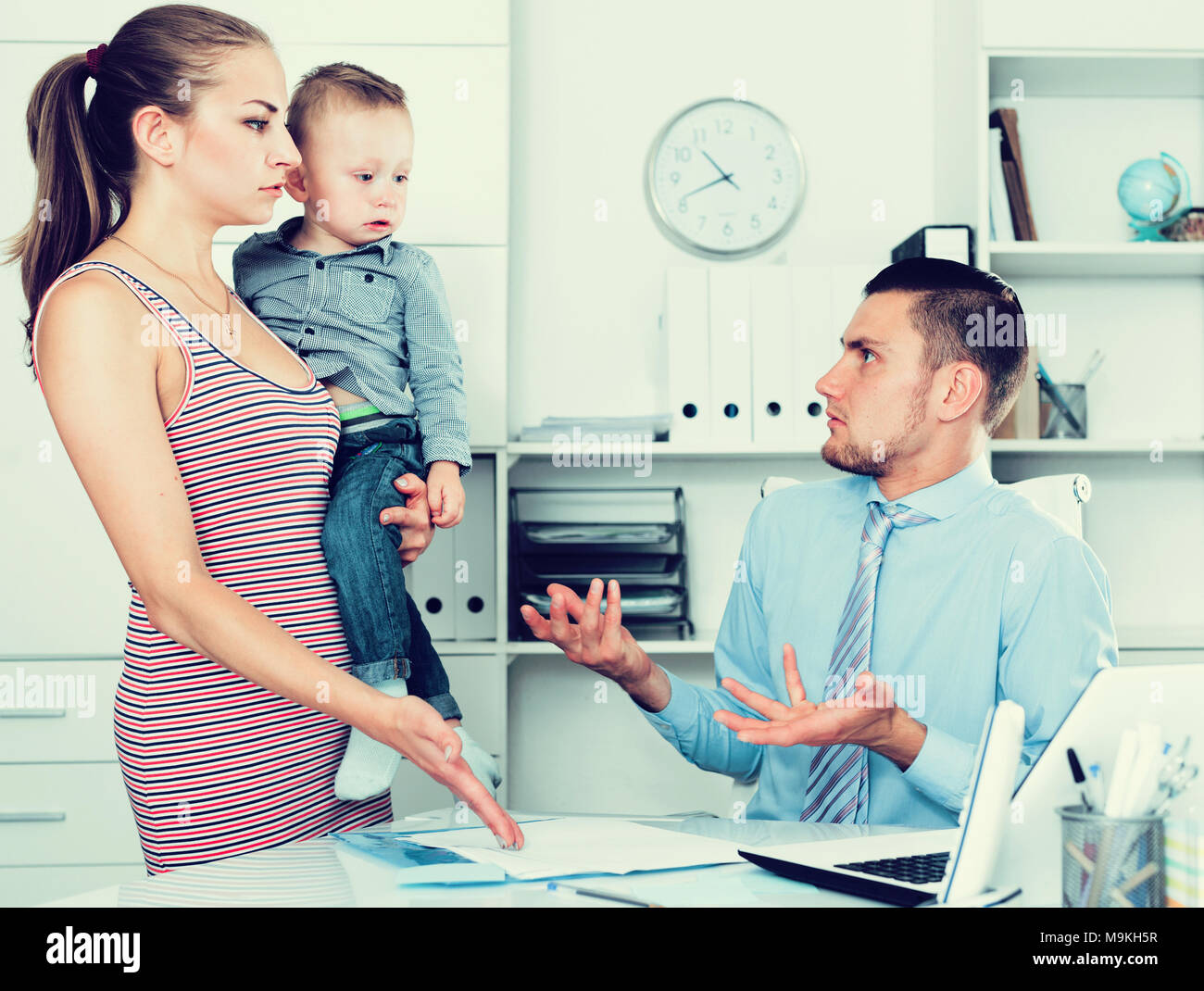 Portrait of frowning manager of insurance company with angry female ...