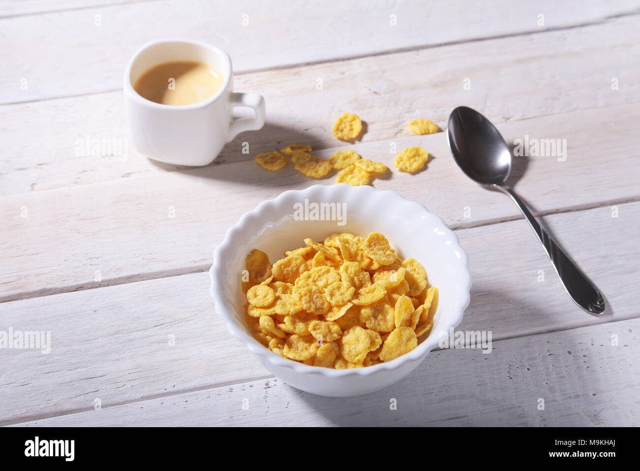 Corn Flakes cereal in a bowl and cap with espresso coffee. Morning ...