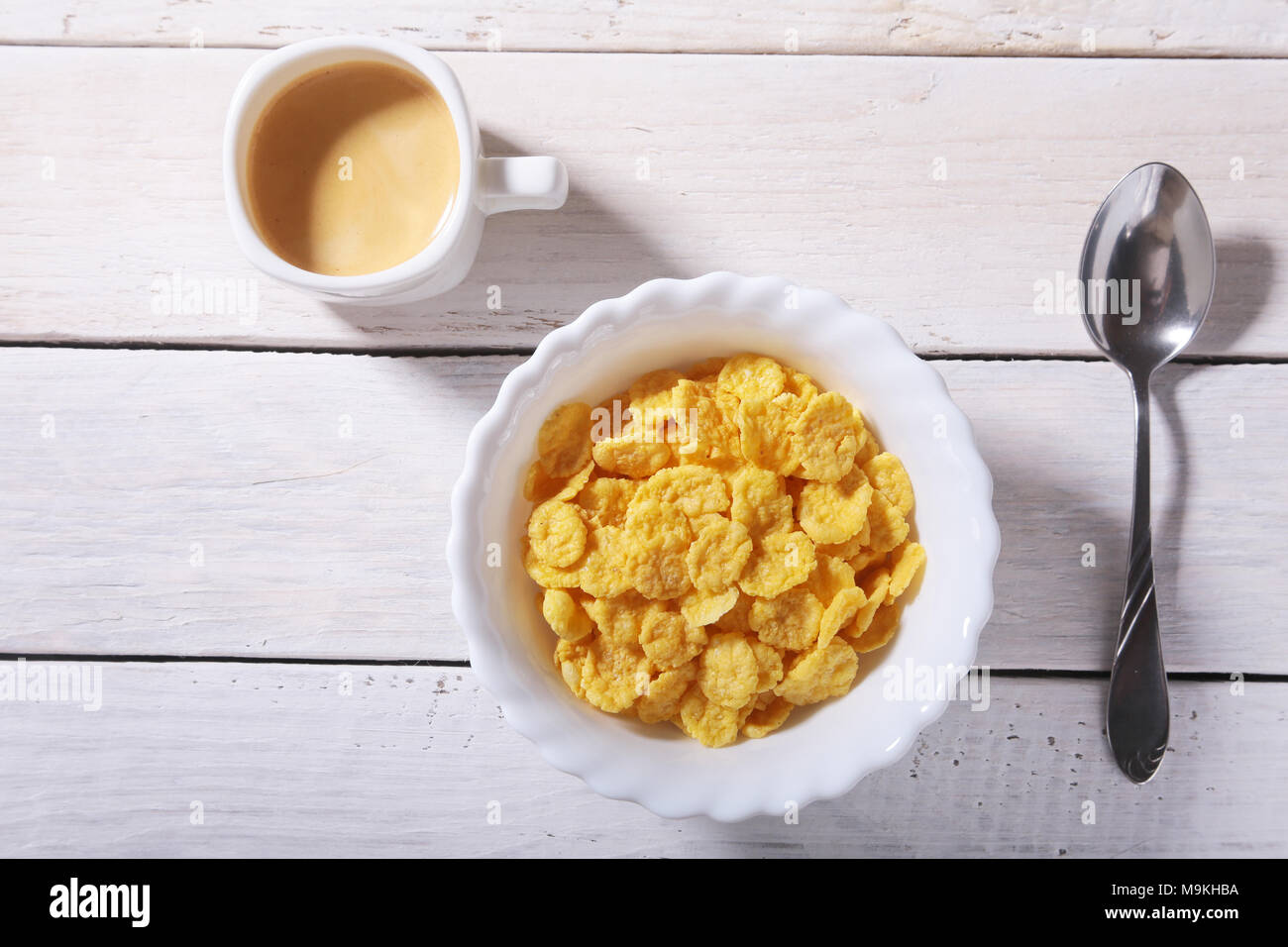Corn Flakes cereal in a bowl and cap with espresso coffee. Morning ...