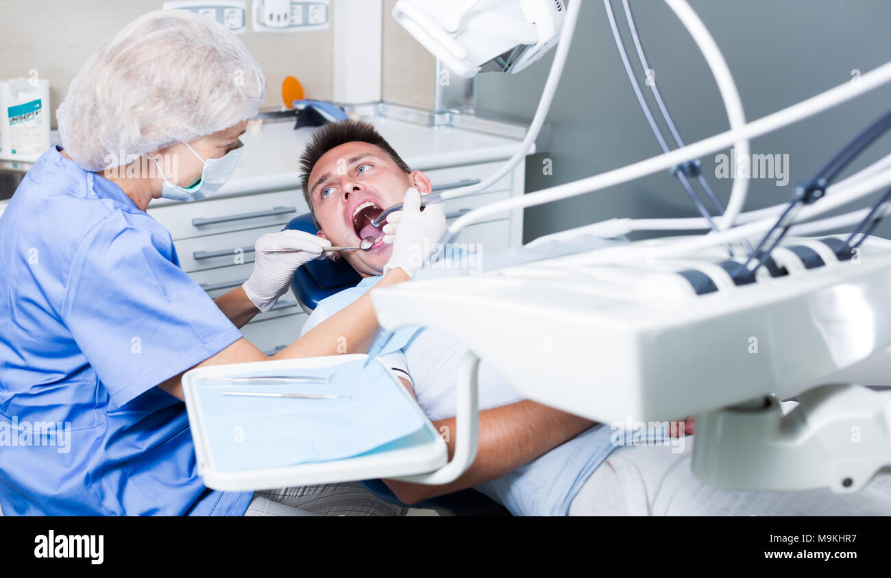 Young man visiting dentist, taking care of his health and dental ...