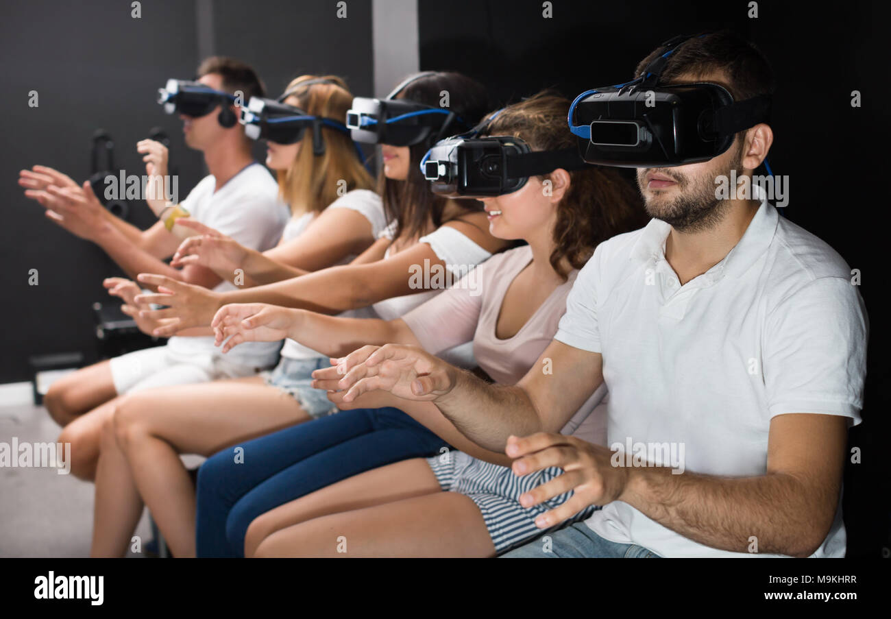 Young happy people having fun with new technology of a vr headset ...