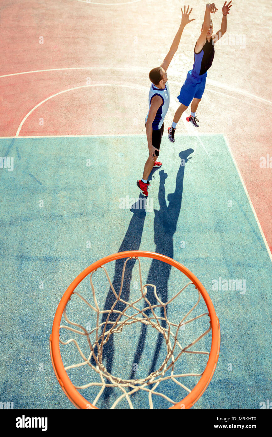 High angle view of basketball player dunking basketball in hoop Stock ...