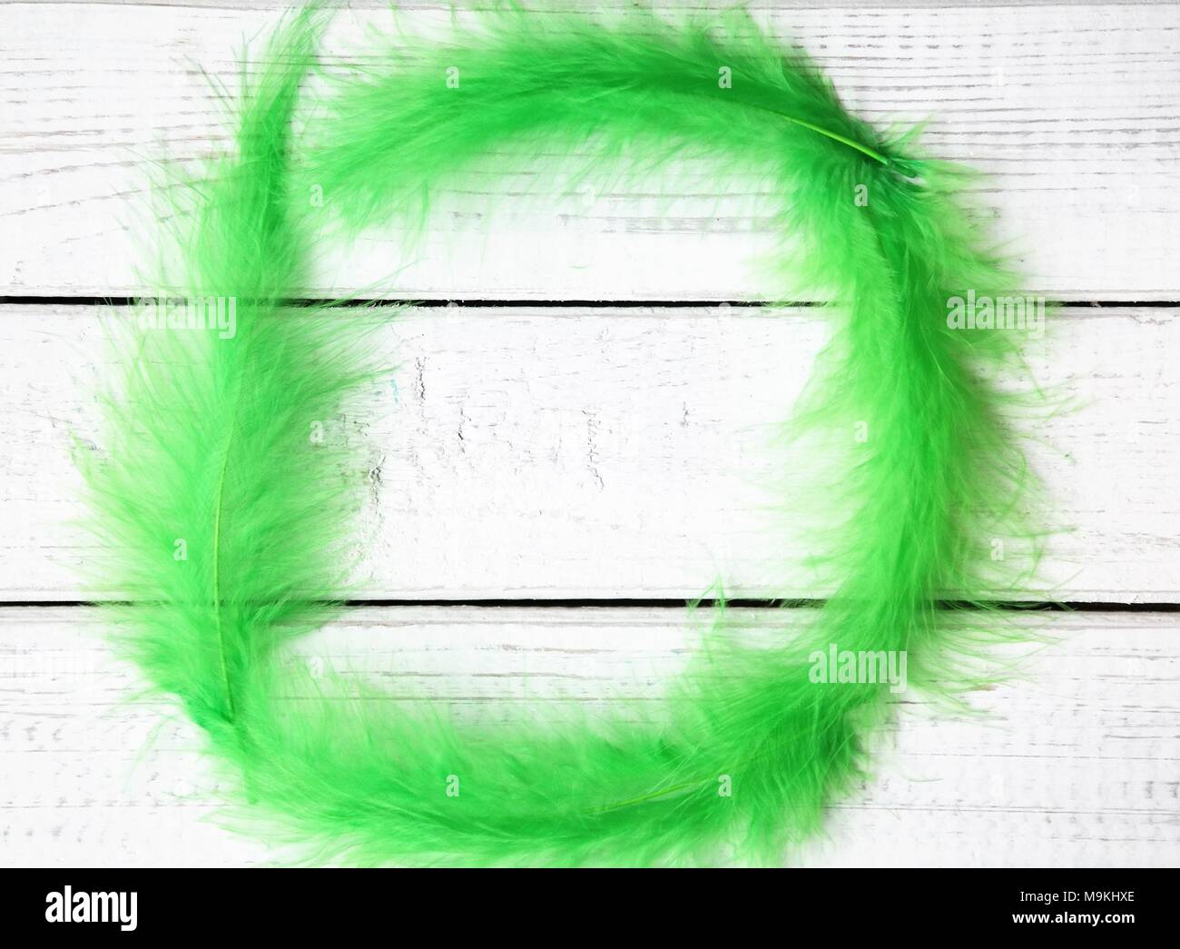 Minimalist Easter concept with soft frame made of neon green feathers ...