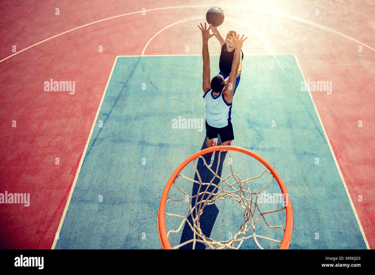 High angle view of basketball player dunking basketball in hoop Stock ...