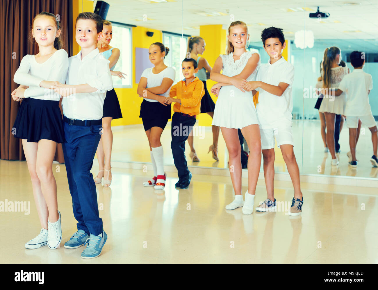 Smiling kids are dancing tango in class Stock Photo - Alamy
