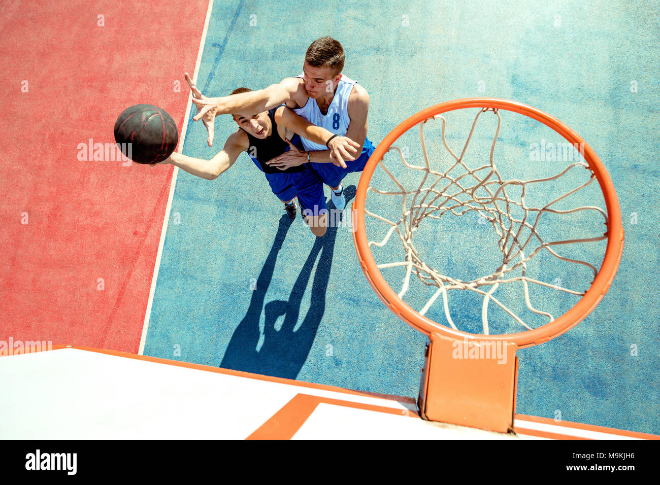 High angle view of basketball player dunking basketball in hoop Stock ...
