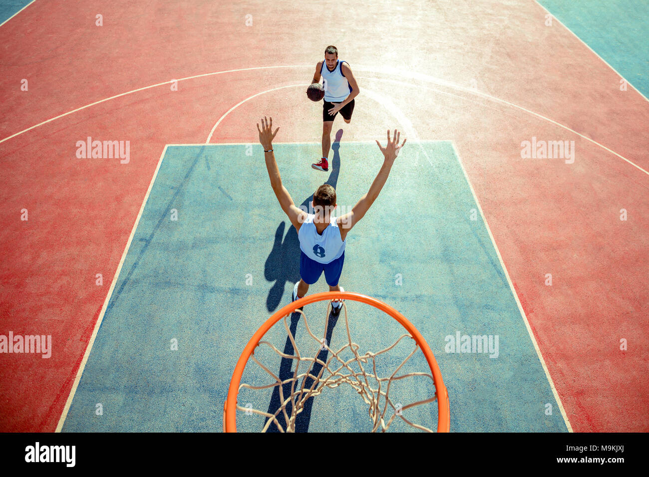High angle view of basketball player dunking basketball in hoop Stock ...