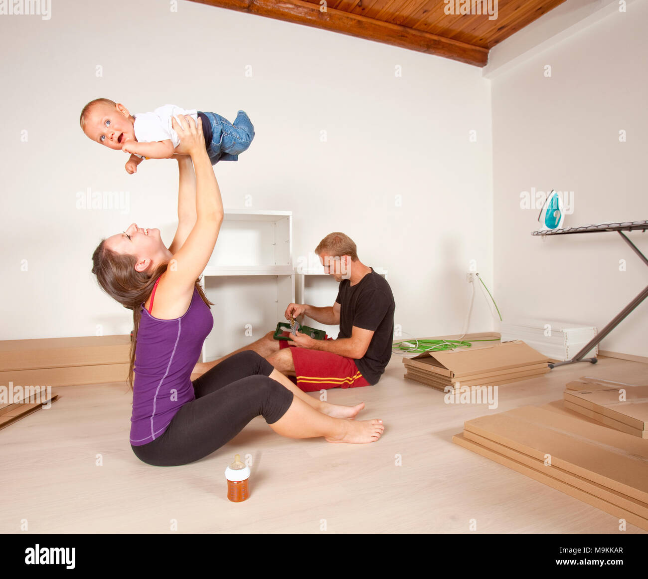 Young Family with a Baby Moving to New Flat Stock Photo - Alamy