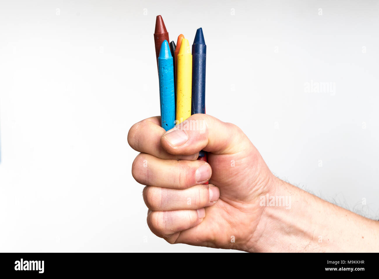 Some multicolored wax crayons in the hand Stock Photo - Alamy