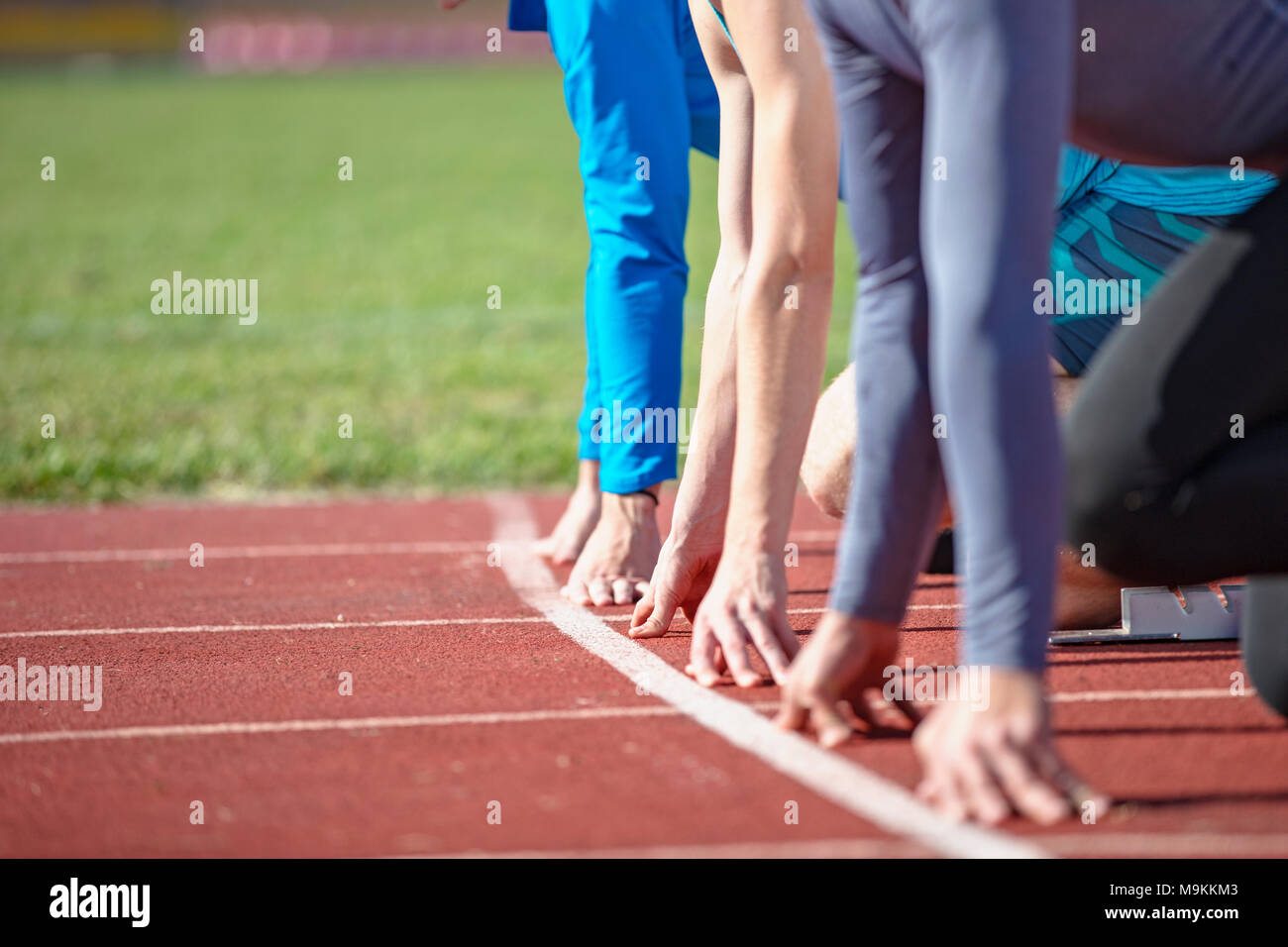 Athletes at the sprint start line in track and field Stock Photo - Alamy