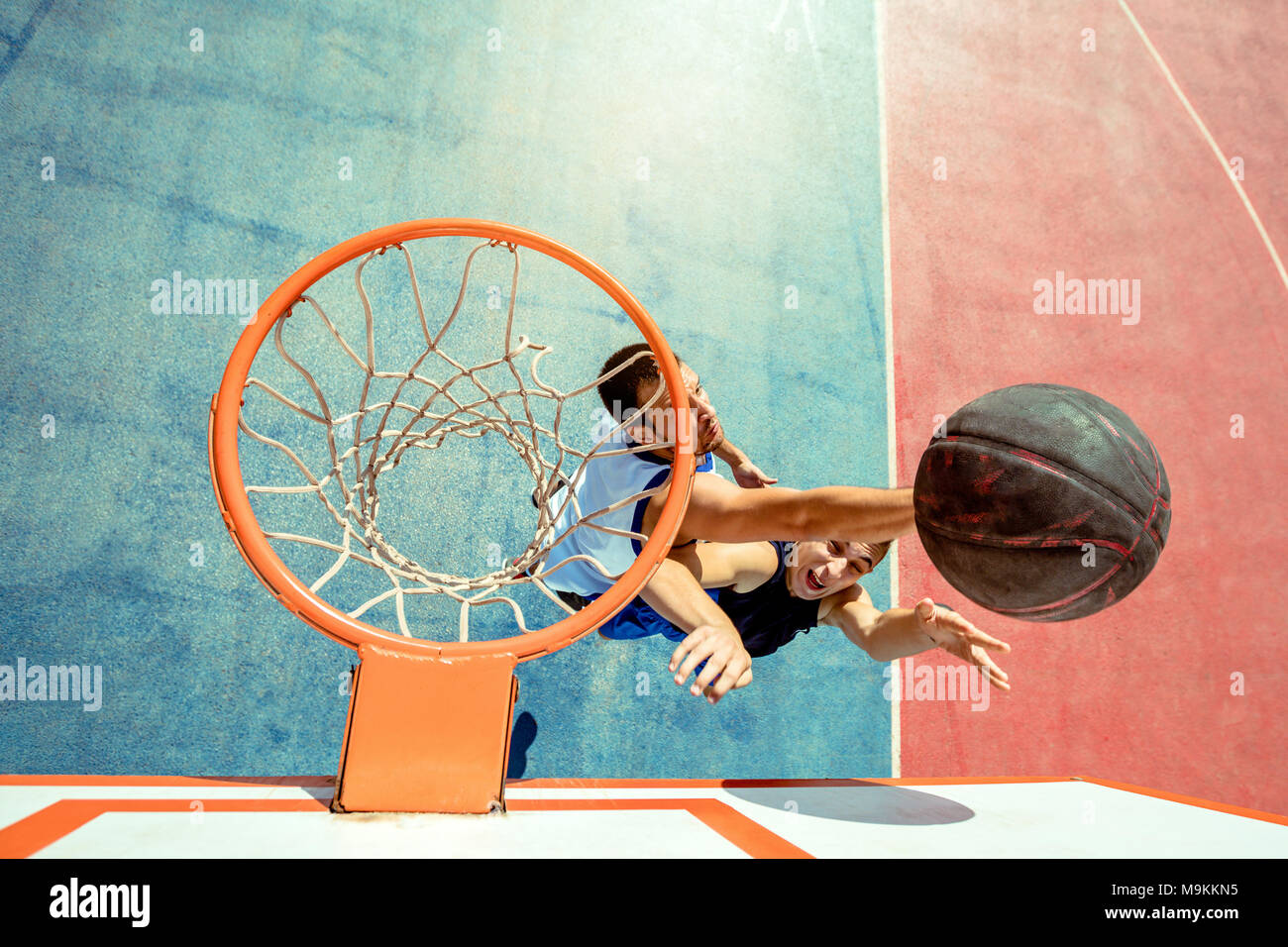 High angle view of basketball player dunking basketball in hoop Stock ...