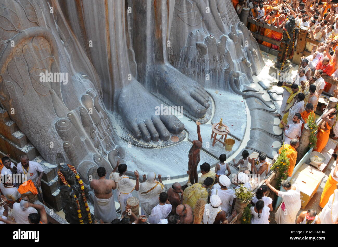 Jain devotees at the foot of gomateshvara bahubali statue ...