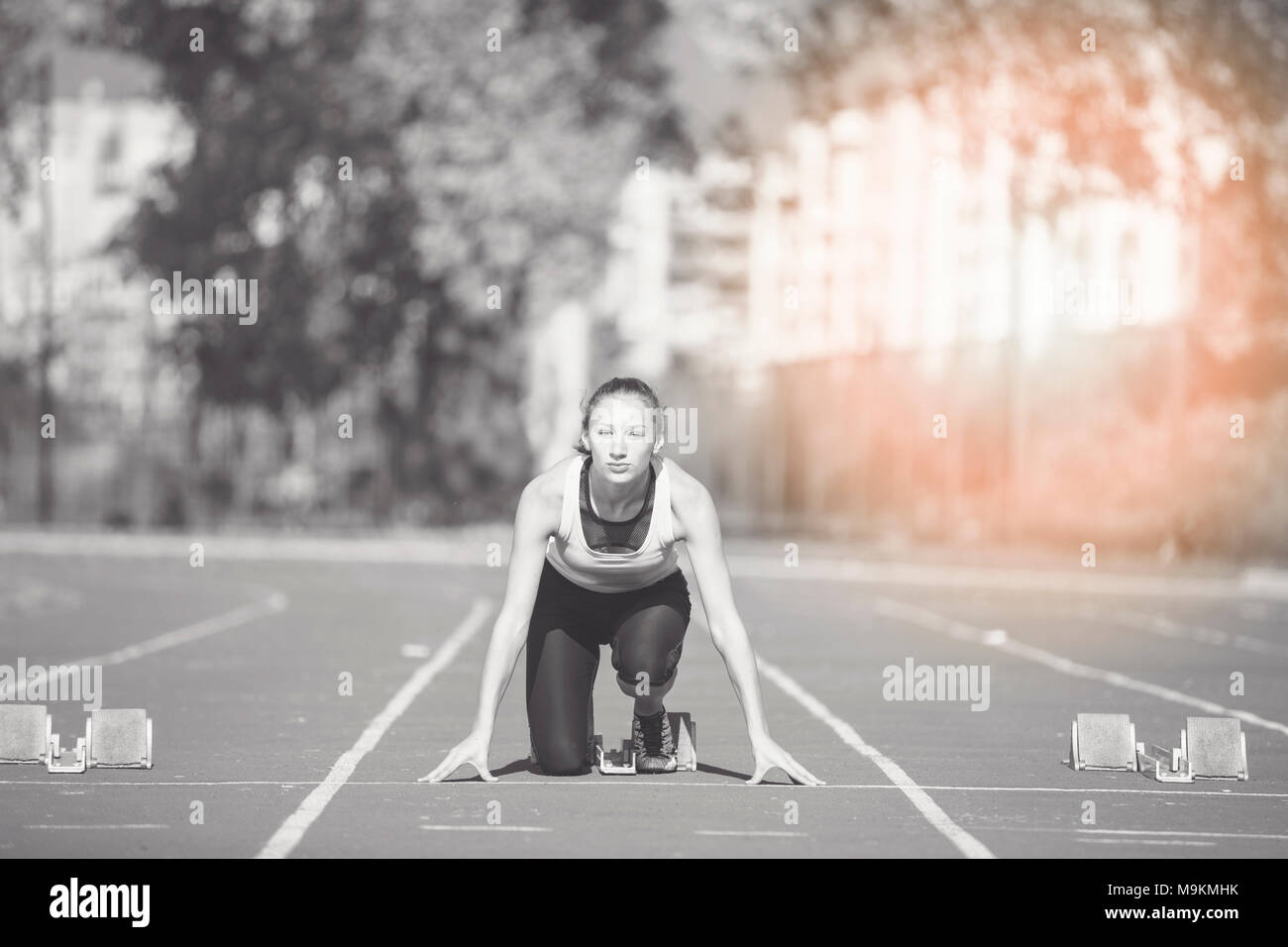Female Sprinter Getting Ready to Start The Race Stock Photo - Alamy