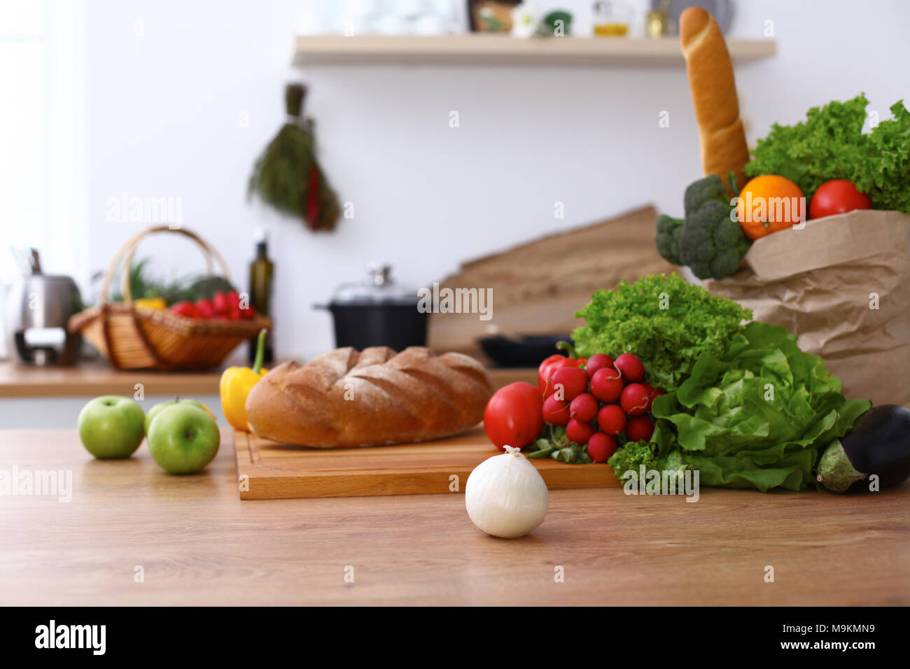 Desk with many fresh vegetables and fruits in the kitchen. Cooking ...