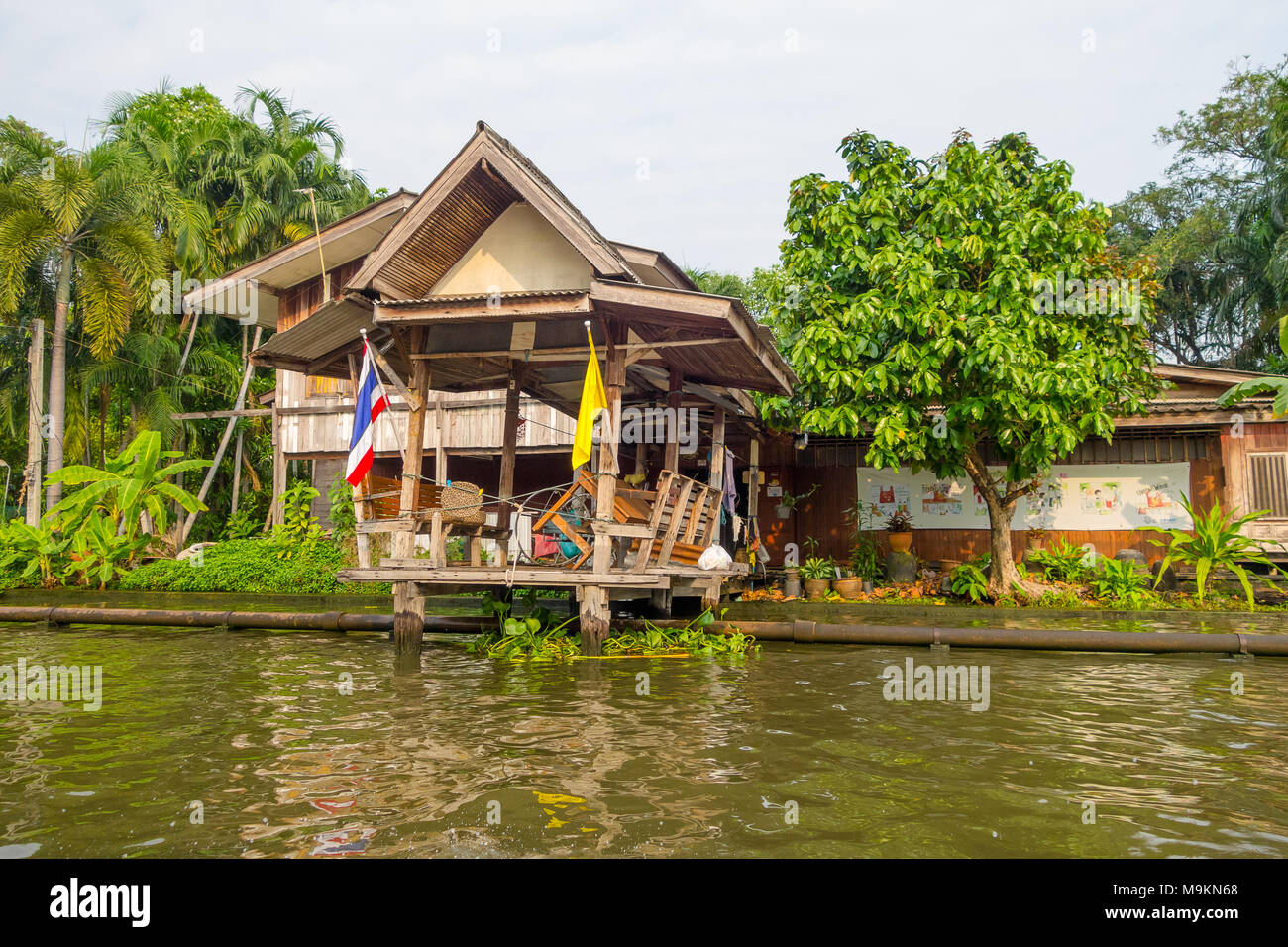 Outdoor view of floating poor house with two flags at the enter of the ...