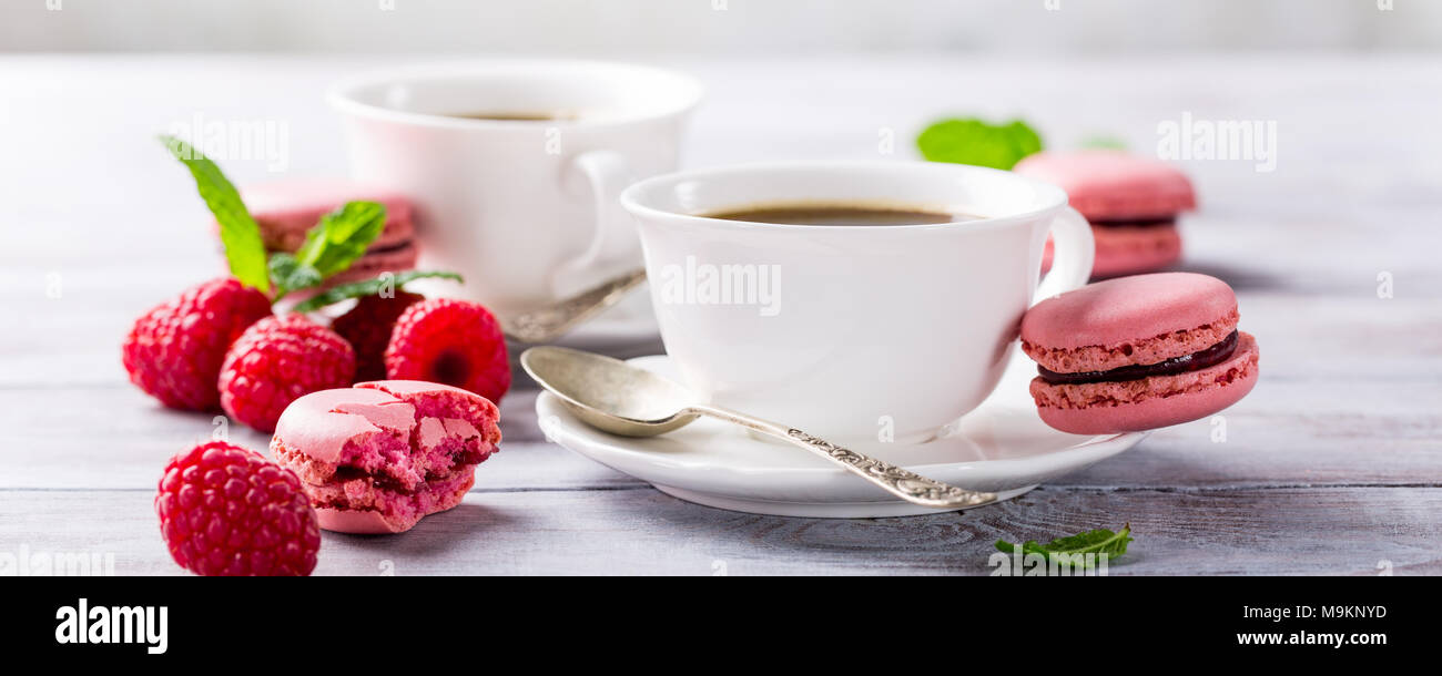 Cup of coffee with french raspberry macaroons Stock Photo - Alamy