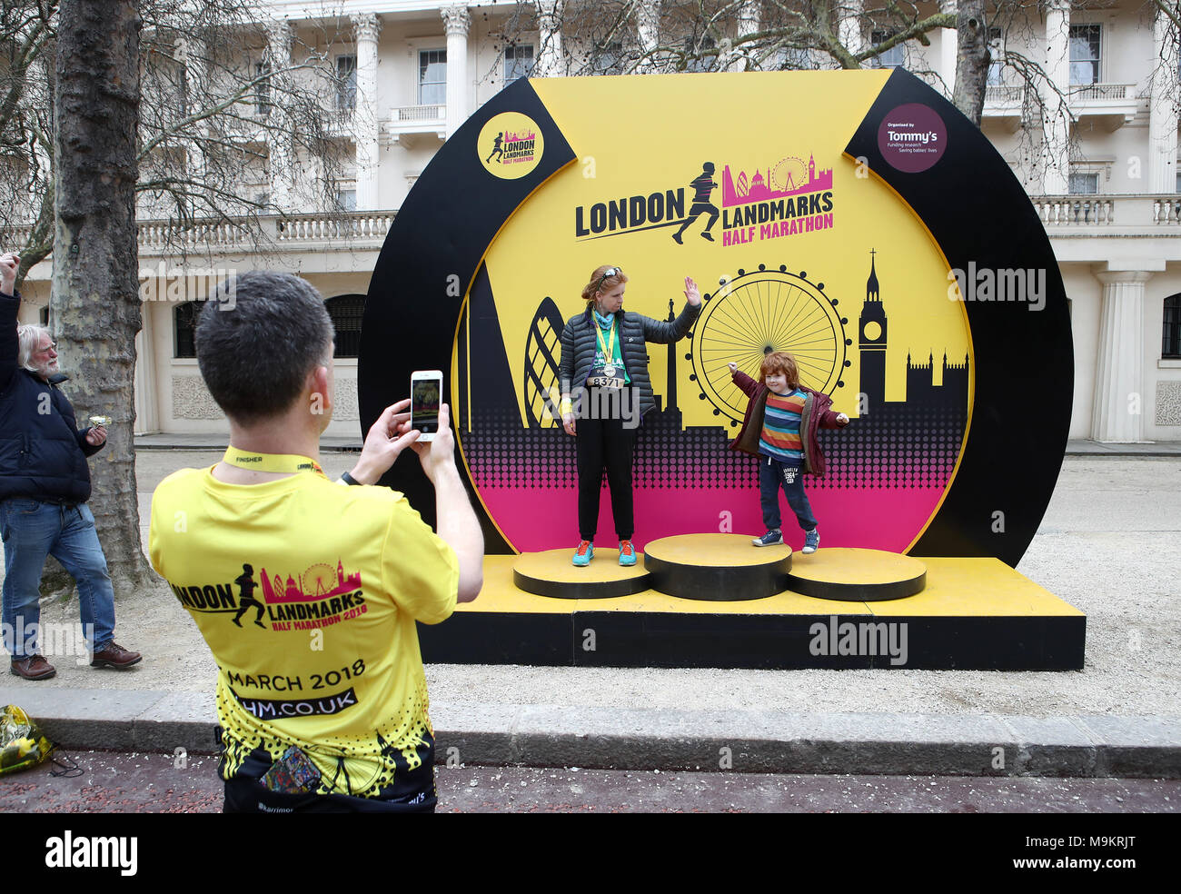Finishers pose on a podium after the 2018 London Landmarks Half ...