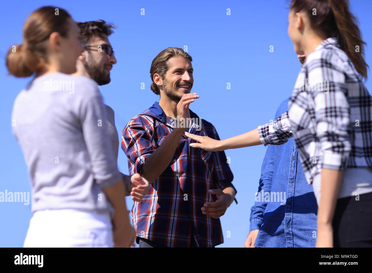 friends greet each other, giving a high five Stock Photo - Alamy