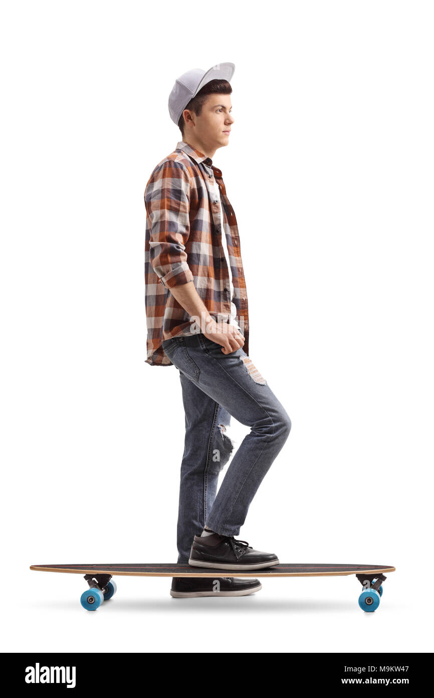Full length profile shot of a teenage skater with a longboard waiting ...