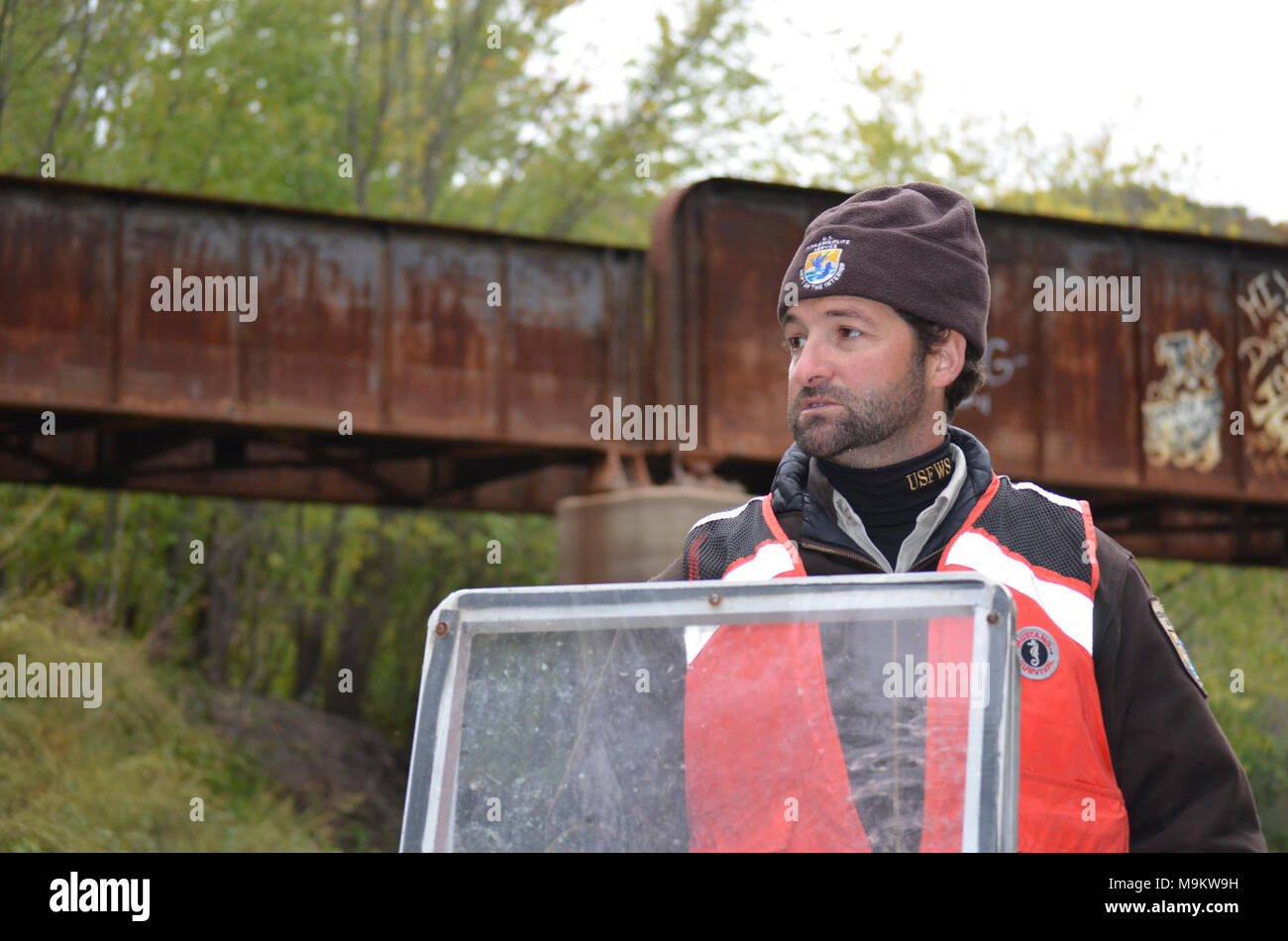 USFWS Project Leader Tracy Hill steers boat underneath old cargo bridge ...