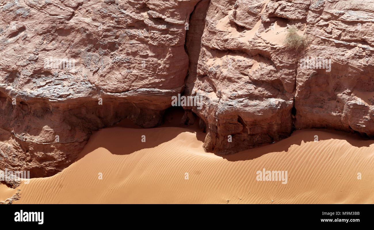 Rock and fine sand with ripple marks and wind ripples in the desert of ...