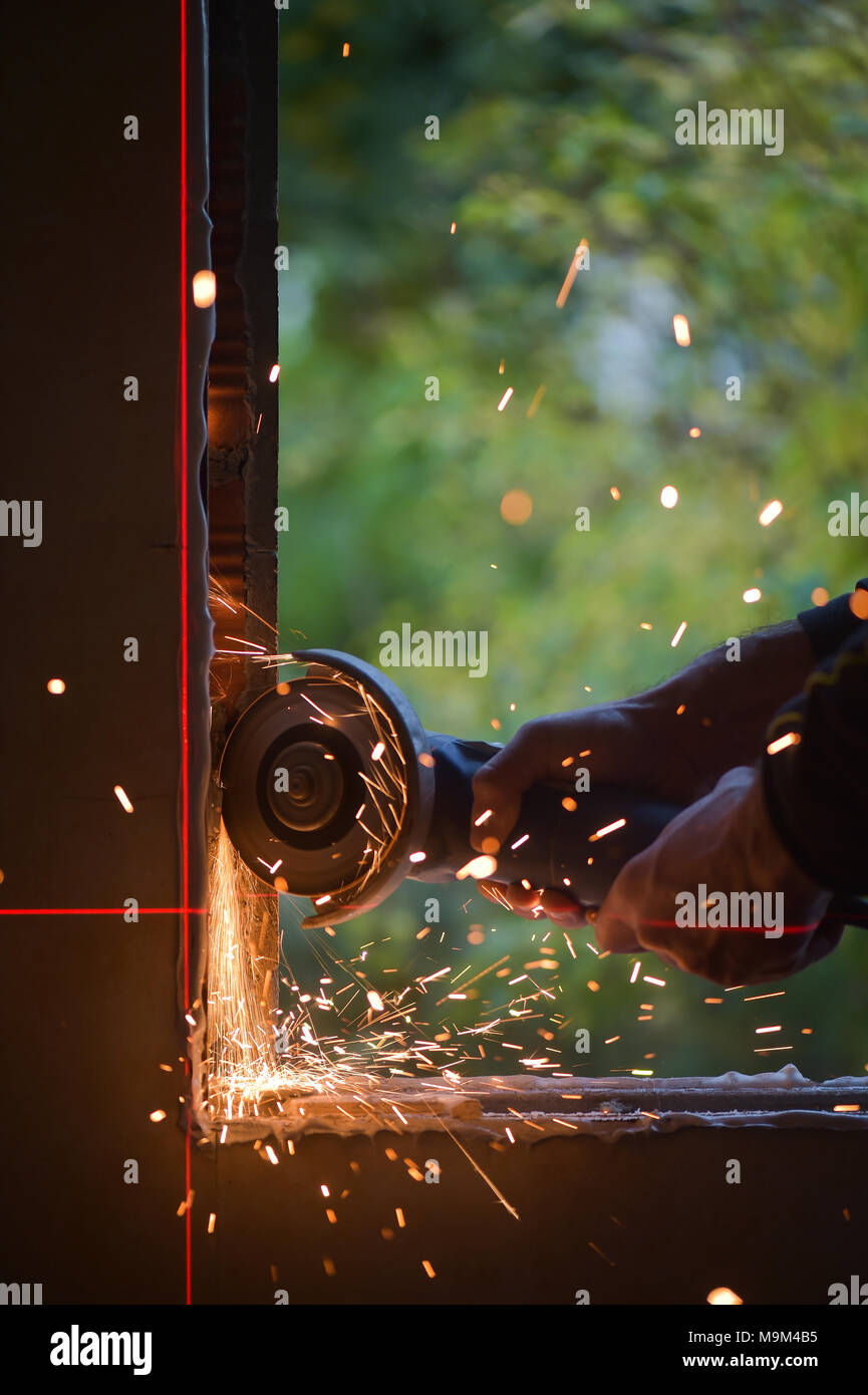 Window renovation-Metal grinding with orange flying sparks Stock Photo ...